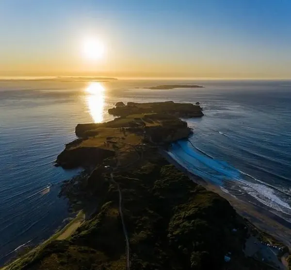 aerial view of the south pacific ocean coast at sunset