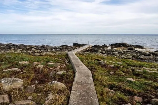 Rocky shoreline with a concrete jetty Our beautiful Wall Art and Photo ...